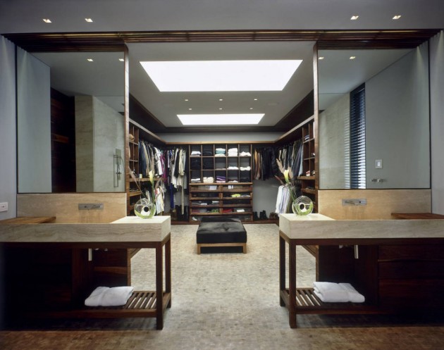 A concrete box floats above a glass-enclosed living room in this house ...