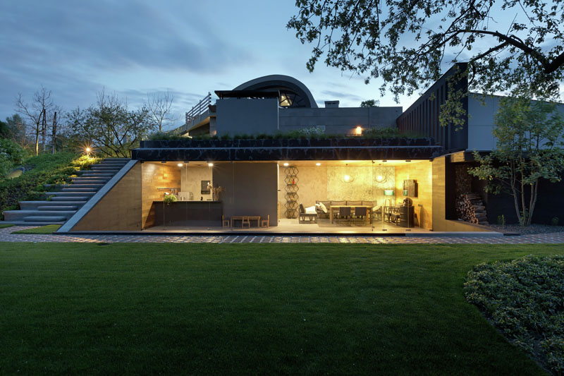 This house with a wavy roof was designed to merge with nature