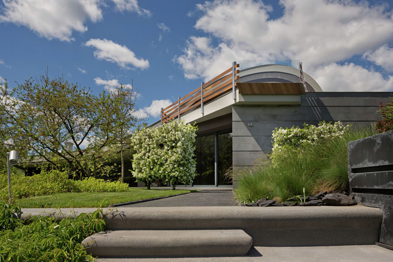 This house with a wavy roof was designed to merge with nature