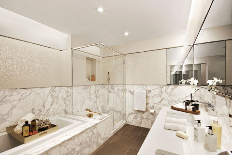 Illuminated drop ceilings emphasize the height inside this New York ...