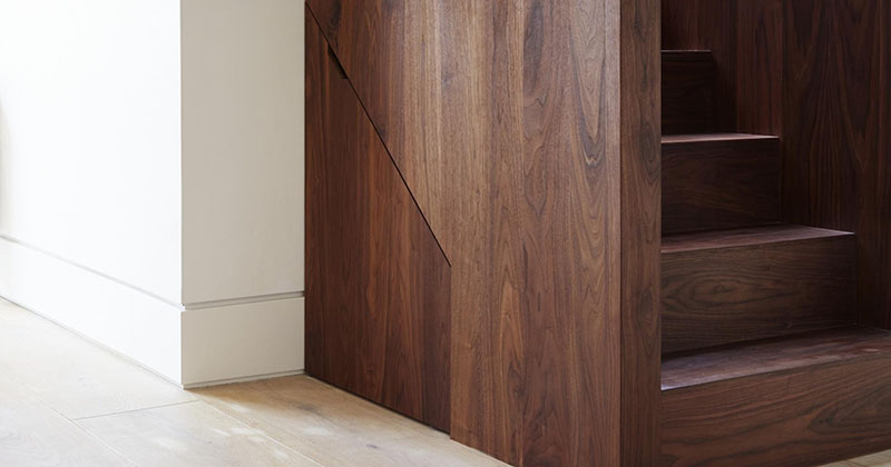 This hidden storage under the stairs almost seamlessly blends in unnoticed