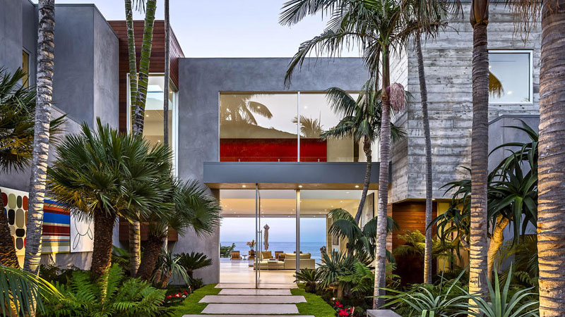 This modern home in Malibu includes plenty of palm trees and ocean views