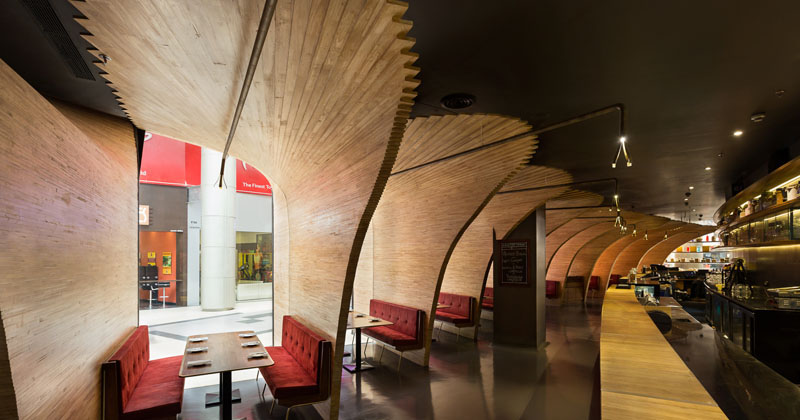 Sculptural wood elements flow from the exterior to the interior of this ...
