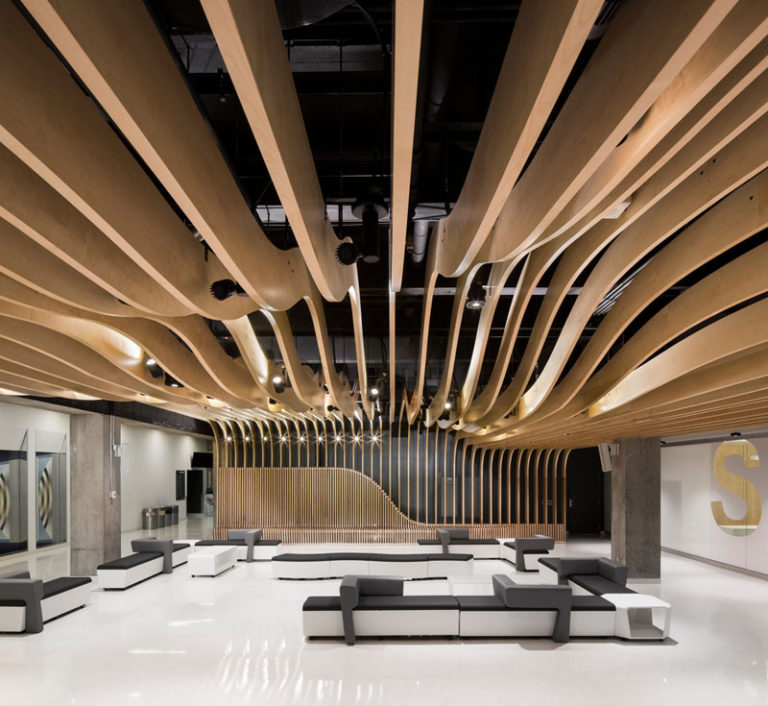 The seat along the wall becomes a dramatic sculptural wood ceiling