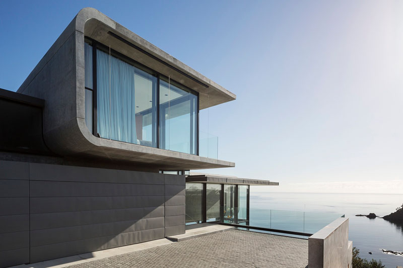 This Concrete House Sits Above A Rocky Cliff Overlooking The Ocean