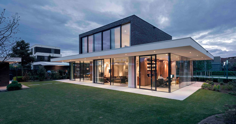The ground floor of this house is almost completely surrounded by windows