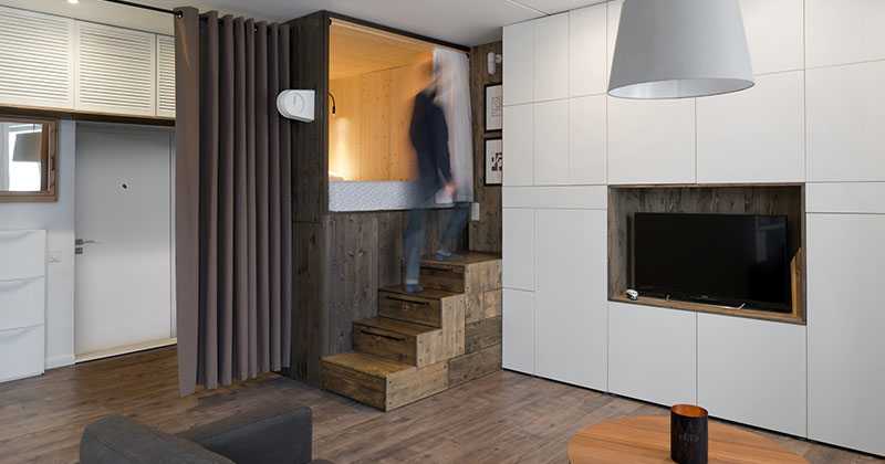 Small Apartment Design Idea - Raised bedroom allows for storage underneath