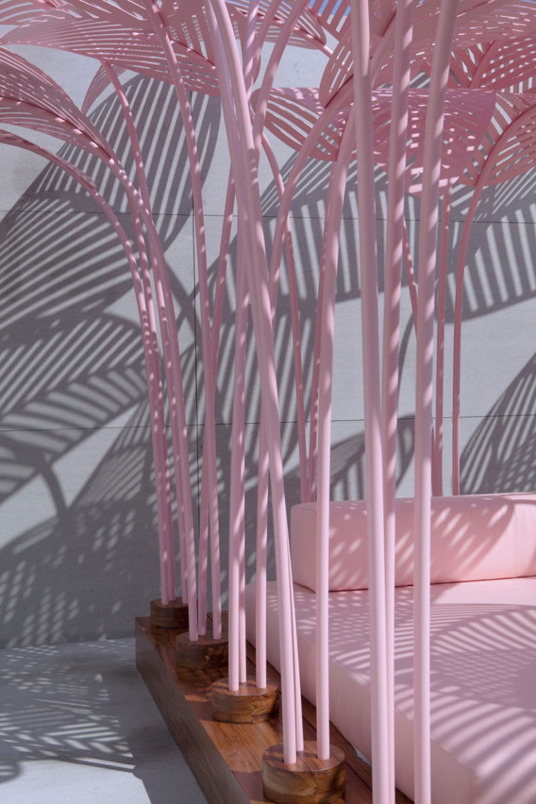 This Outdoor Sun Lounger Is Shaded By A Forest Of Pink Palm Leaves