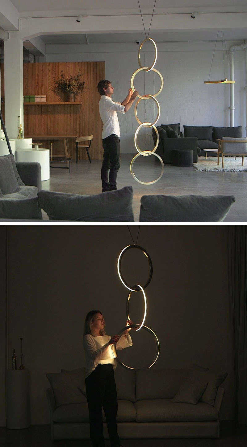 This Vertical Pendant Light Is Made Using Brass Rings