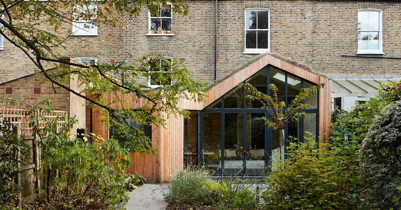 A Modern Wood Rear Extension Was Added To This Home In England
