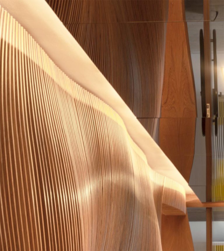 A Wavy Sculptural Hallway Greets Guests As They Arrive At This Apartment