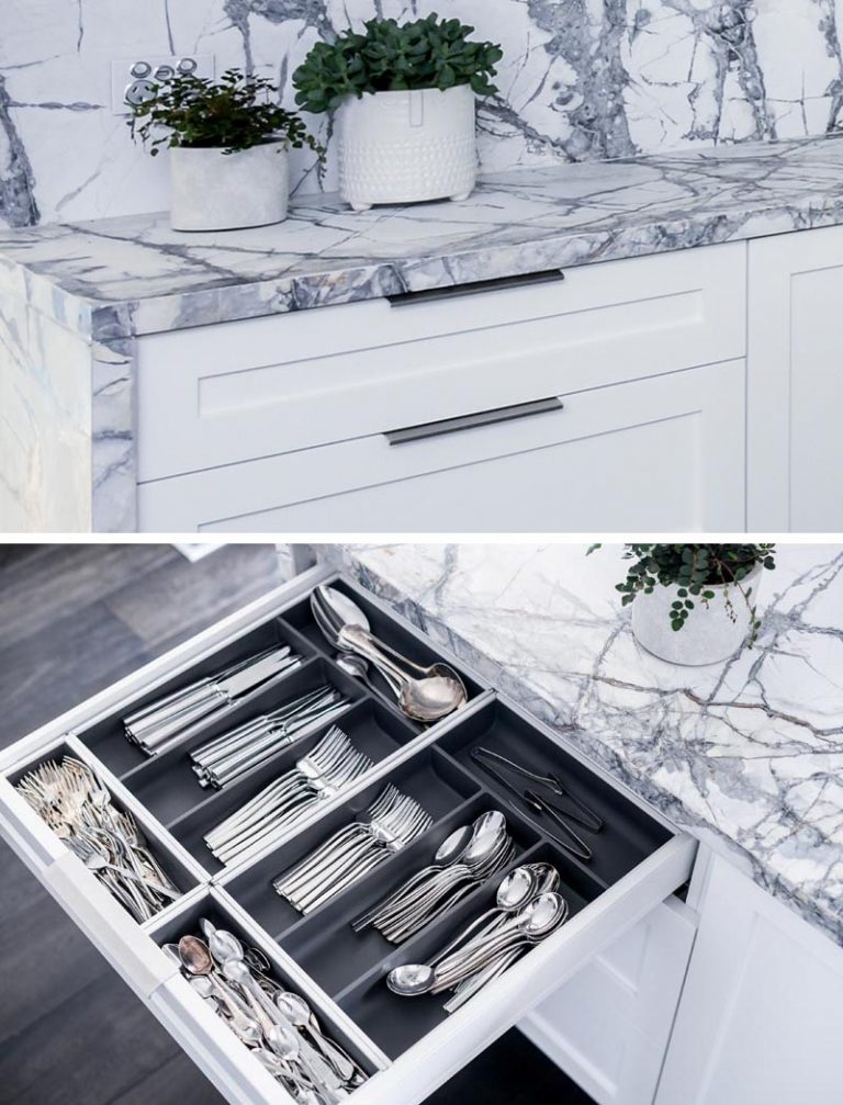 This Kitchen With A Grey Marble Countertop Is Full Of Storage And ...