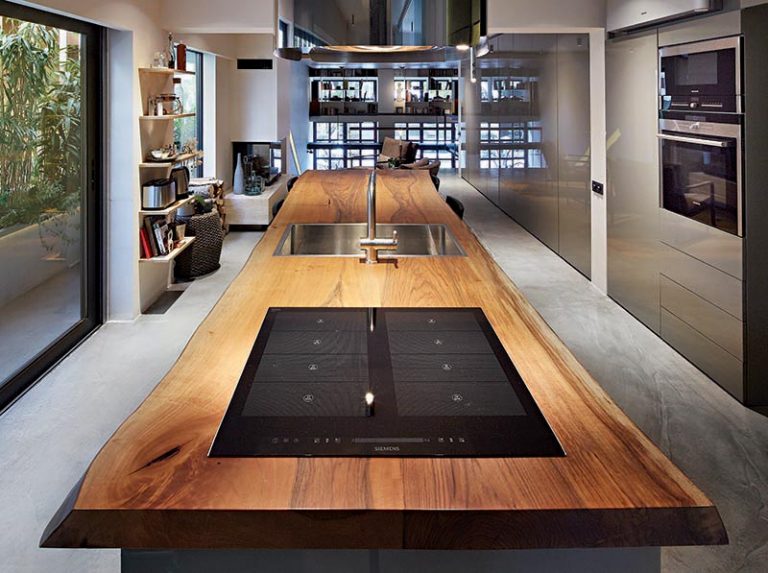 A Long Kitchen Island With A Live Edge Countertop