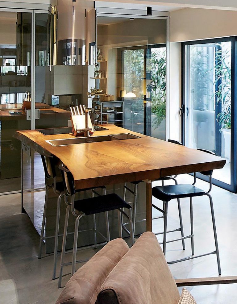 A Long Kitchen Island With A Live Edge Countertop