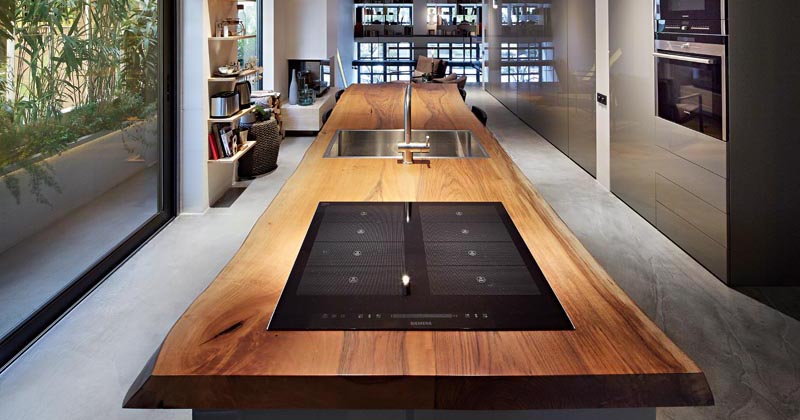 A Long Kitchen Island With A Live Edge Countertop