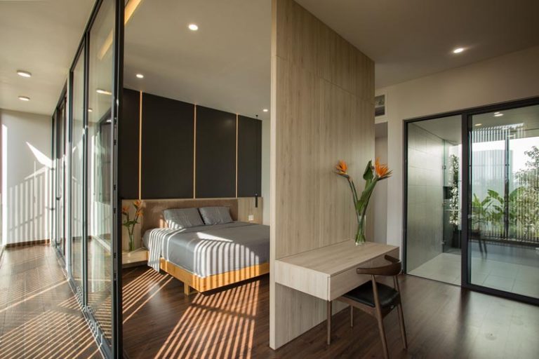 A Room Divider In A Bedroom Creates A Space For A Floating Desk