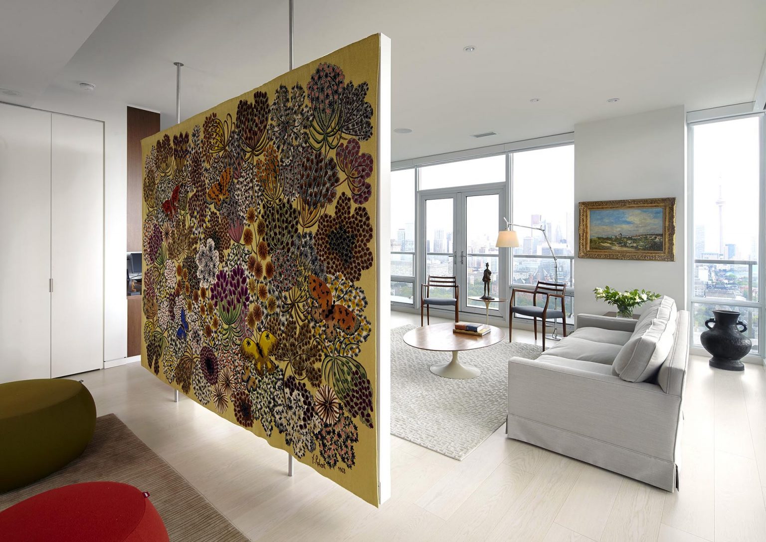 A Floating Room Divider Is Used To Display Artwork In This Apartment