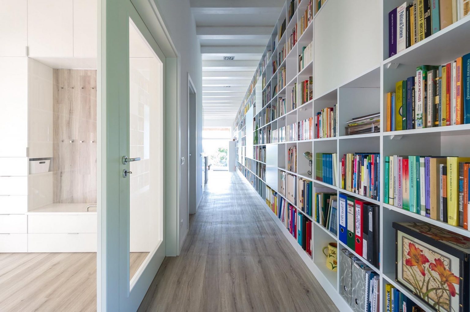 This Long Wall Of Shelving Incorporates Storage, A Fireplace, Windows ...