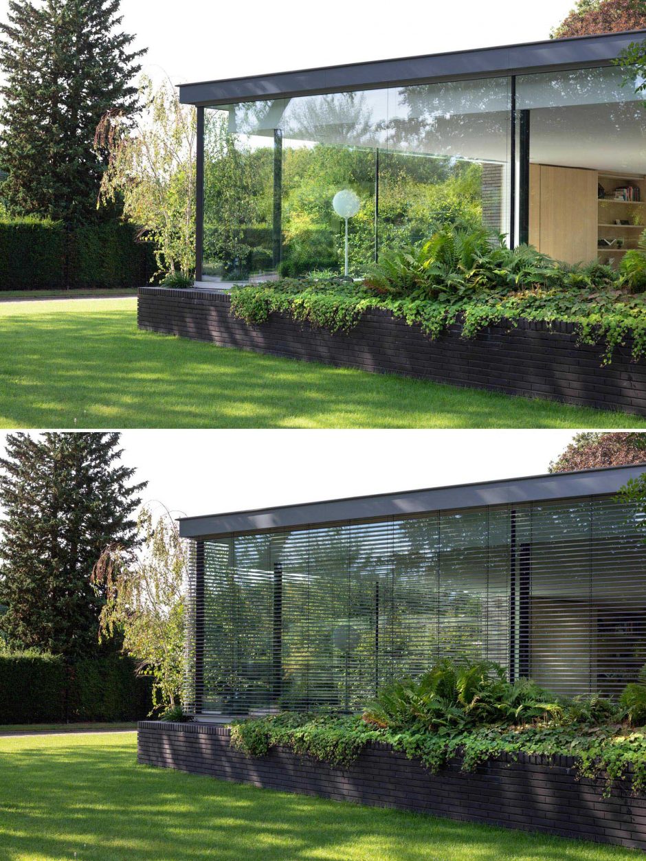 This Home Combines A Black Brick Exterior With Large Glass Walls For A ...