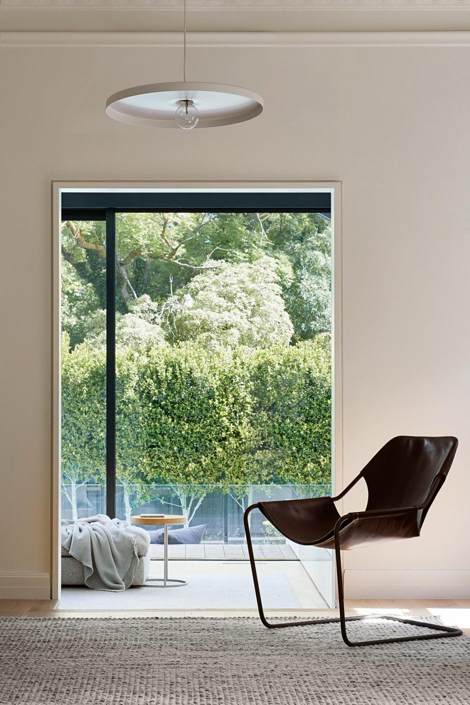 A Wall Of Windows With Sliding Glass Doors Connect The Interior Of This ...