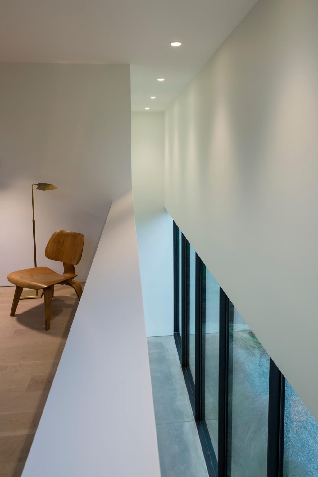A Home Office Was Made Possible By Building A Desk Along A Wall Of ...