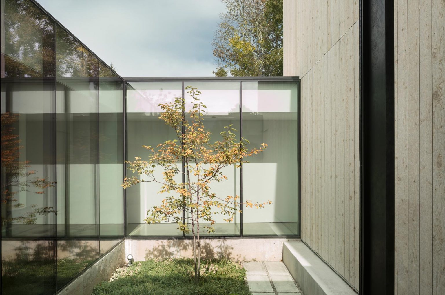 A Home Office Was Made Possible By Building A Desk Along A Wall Of ...