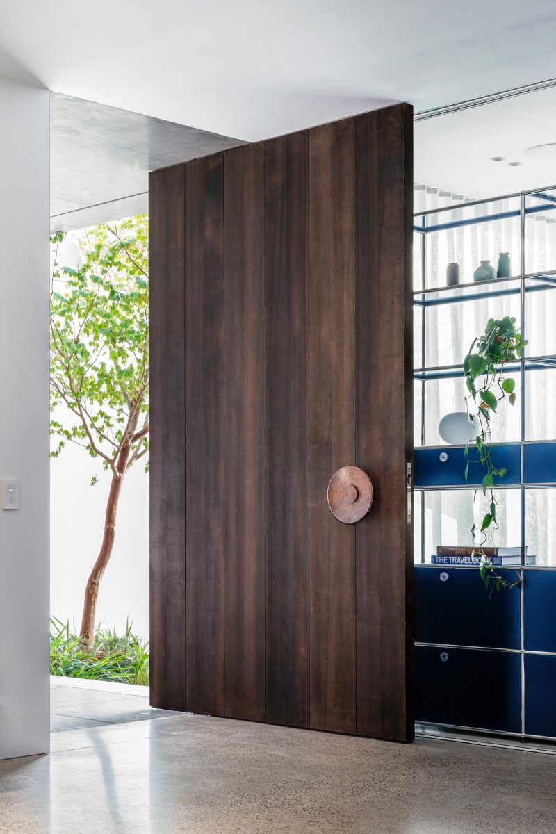 A Large Wood Door With A Disc For A Handle Is An Impressive Statement ...
