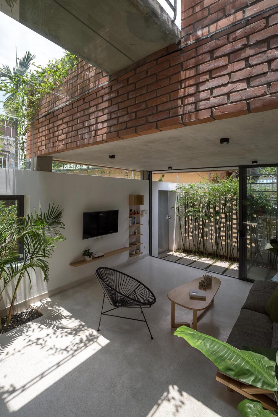 A Rooftop Lounge And Garden Surrounded By Brick Walls Was Designed For ...