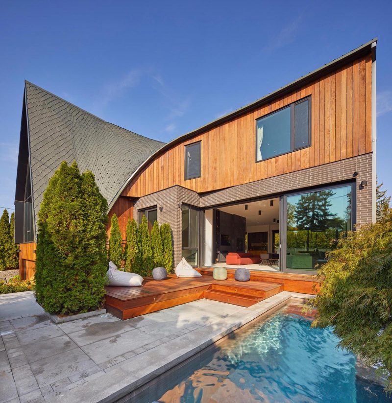 A Curved Roof Covered In Diamond-Shaped Zinc Shingles Adds A Creative ...