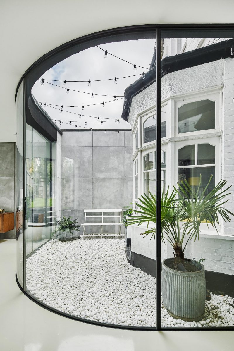 This Home Extension Wraps Around A Bay Window Creating A Small Courtyard