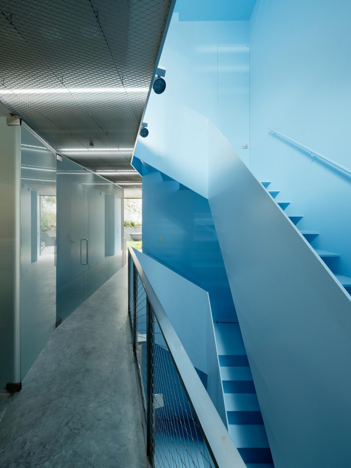 The Wood Exterior Of This Home Hides A Remarkable Blue Staircase Inside