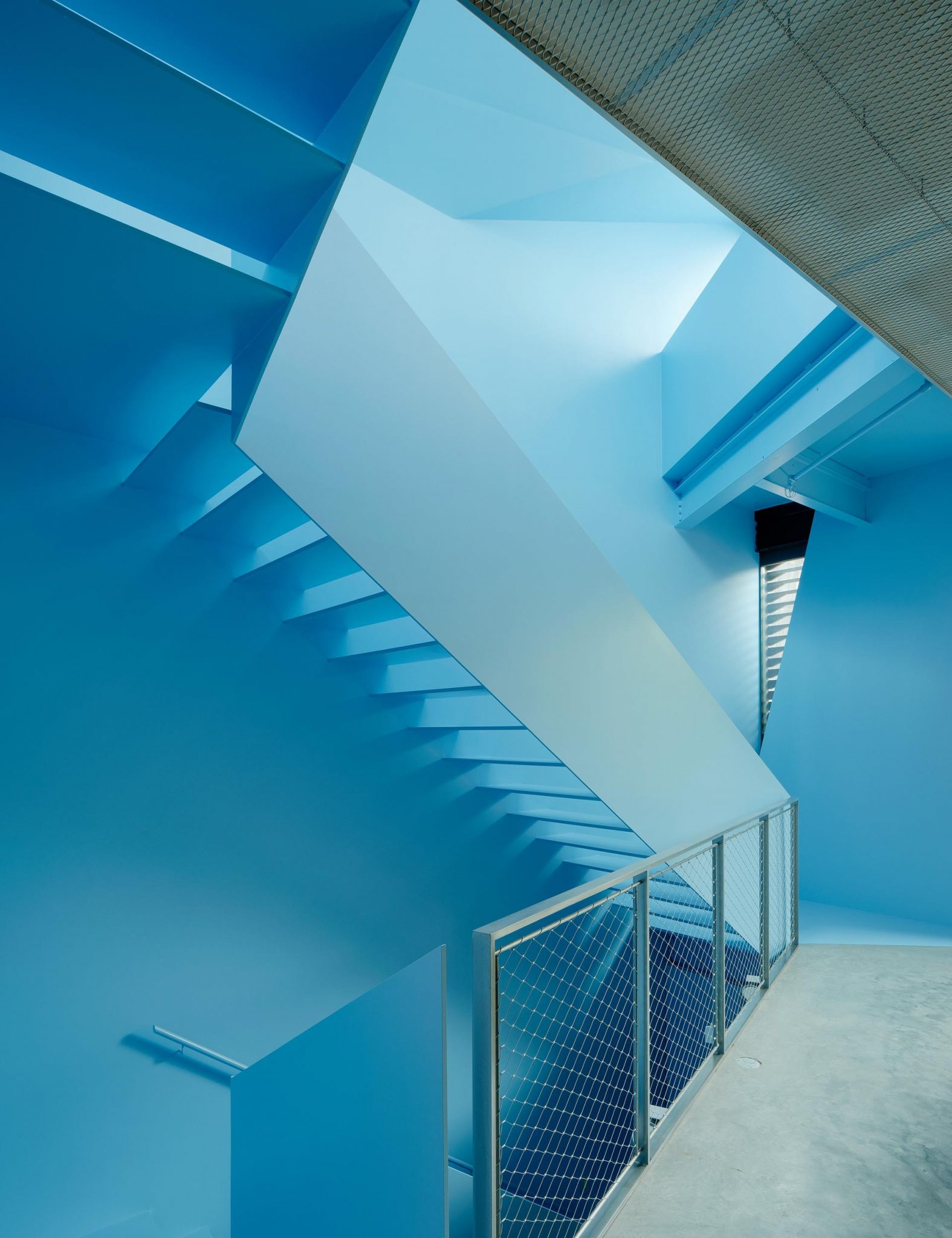 The Wood Exterior Of This Home Hides A Remarkable Blue Staircase Inside