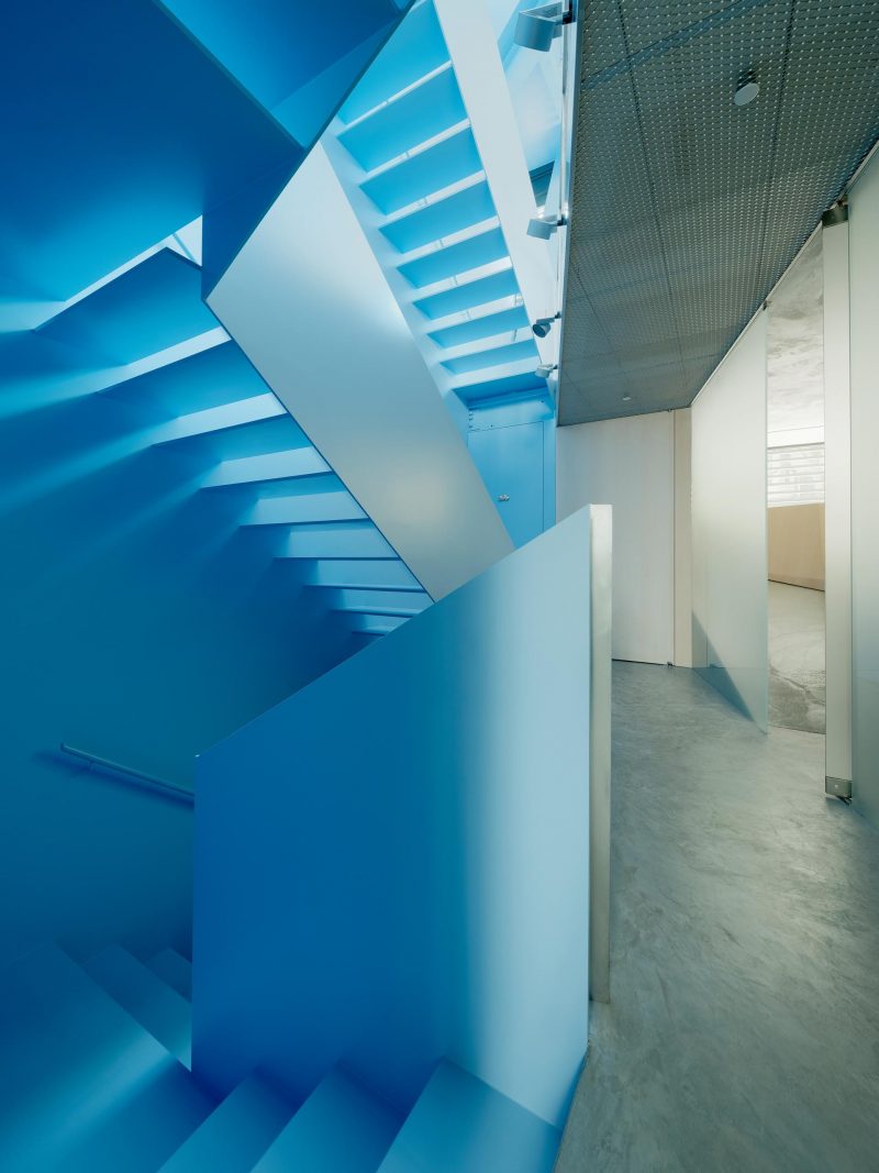 The Wood Exterior Of This Home Hides A Remarkable Blue Staircase Inside