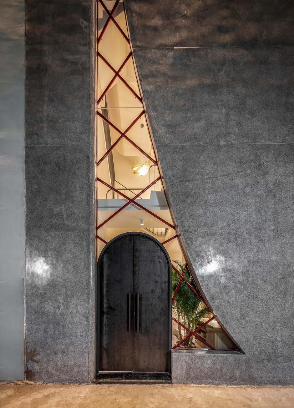 An Oversized Window That Integrates An Arched Front Door Creates A ...