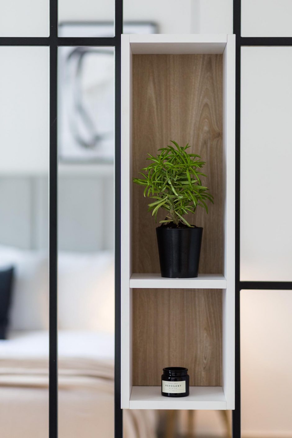 This Black Framed Room Divider Allows The TV To Be Used From Both Sides