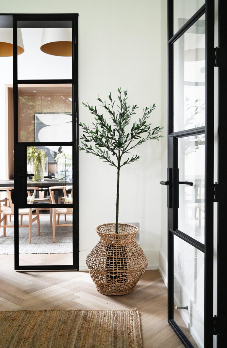 A Grid Of Square Black Window Frames Cover The Back Wall Of This ...