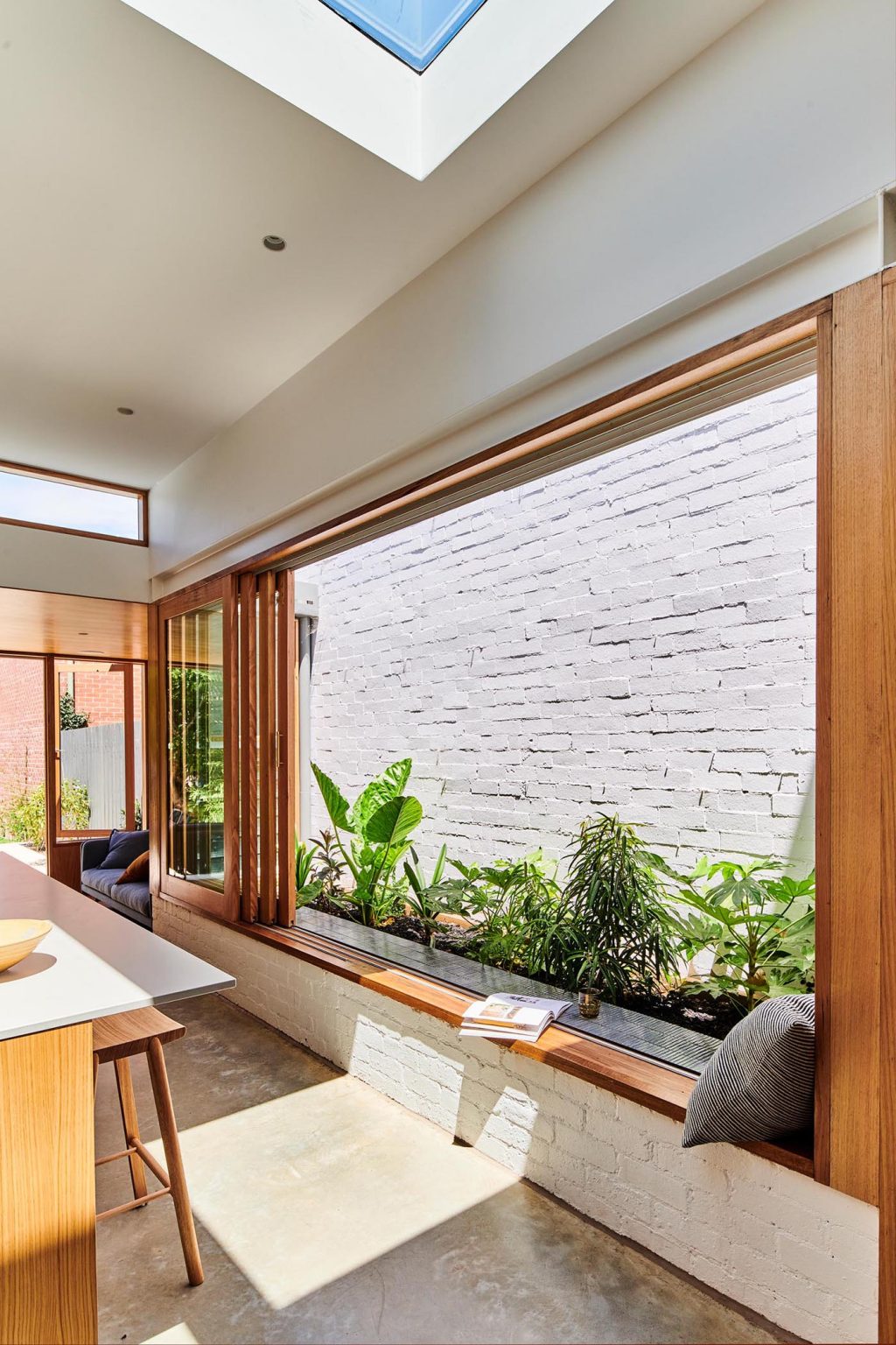 A Large Window Opens This Kitchen To A Side Garden