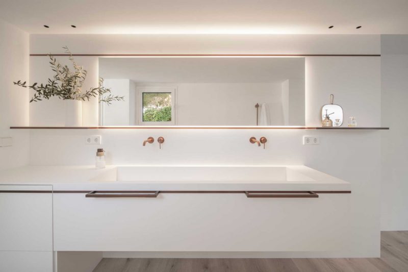 Copper Tones Are Balanced By White Corian In This Minimalist Bathroom