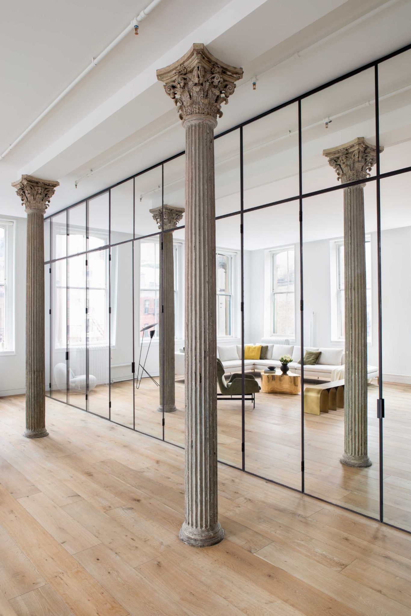 A Large Mirrored Wall Is A Prominent Feature Of This Apartment An ...