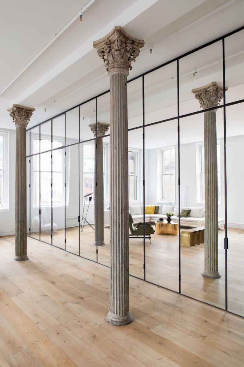 A Large Mirrored Wall Is A Prominent Feature Of This Apartment An ...
