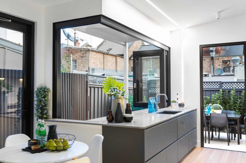A Wall Of Bi-Fold Windows Open This Kitchen To The Outdoors