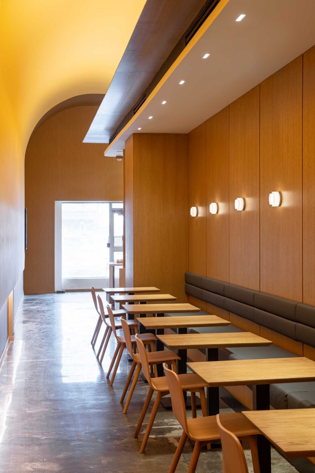 This Pancake Cafe Used A Bold Yellow To Highlight Its Curved Ceiling