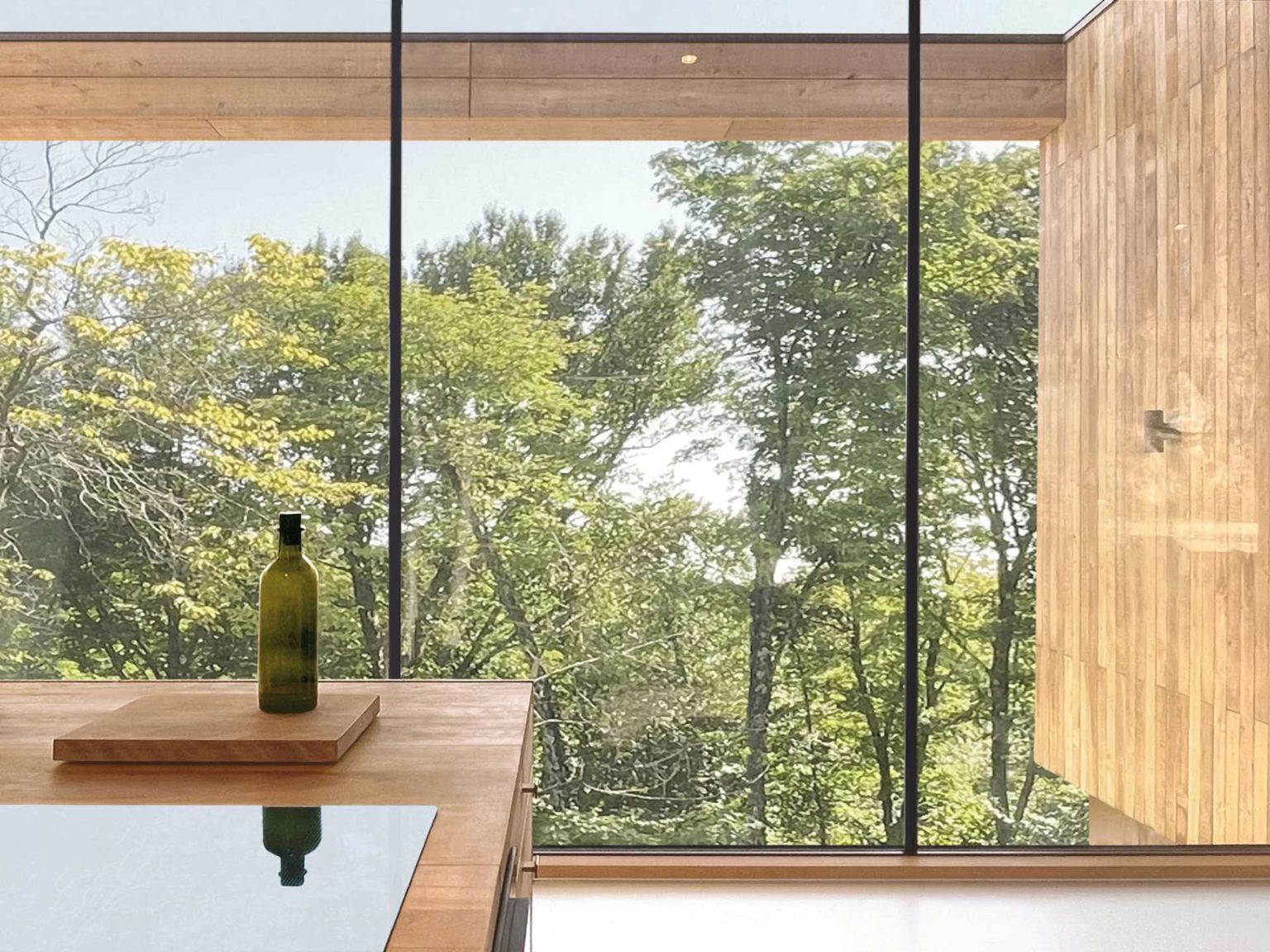 Wood And Glass Frame The Tree Views At This Home In The Mountains