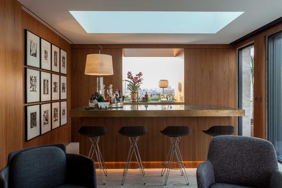 A Full-Wall Bookshelf With LED Lighting Frames The Windows Like Artwork ...