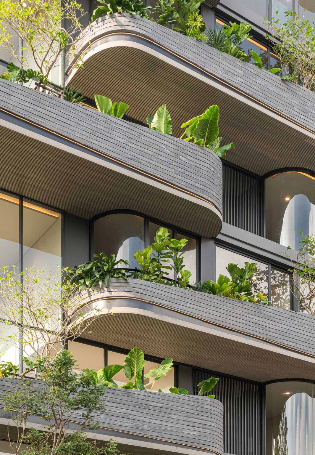 Lighting Is Used To Highlight The Rounded Balconies Of This Building