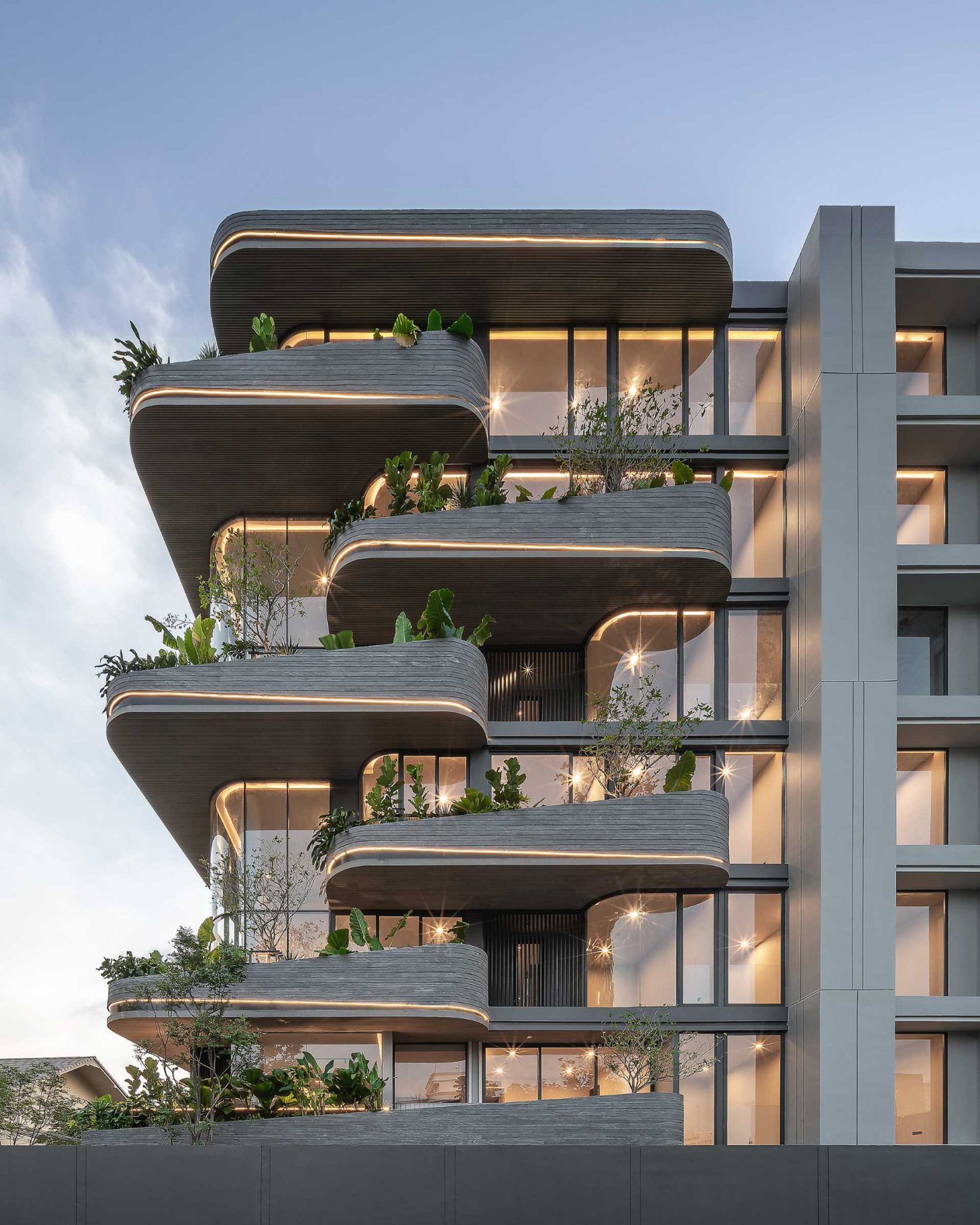 Lighting Is Used To Highlight The Rounded Balconies Of This Building ...