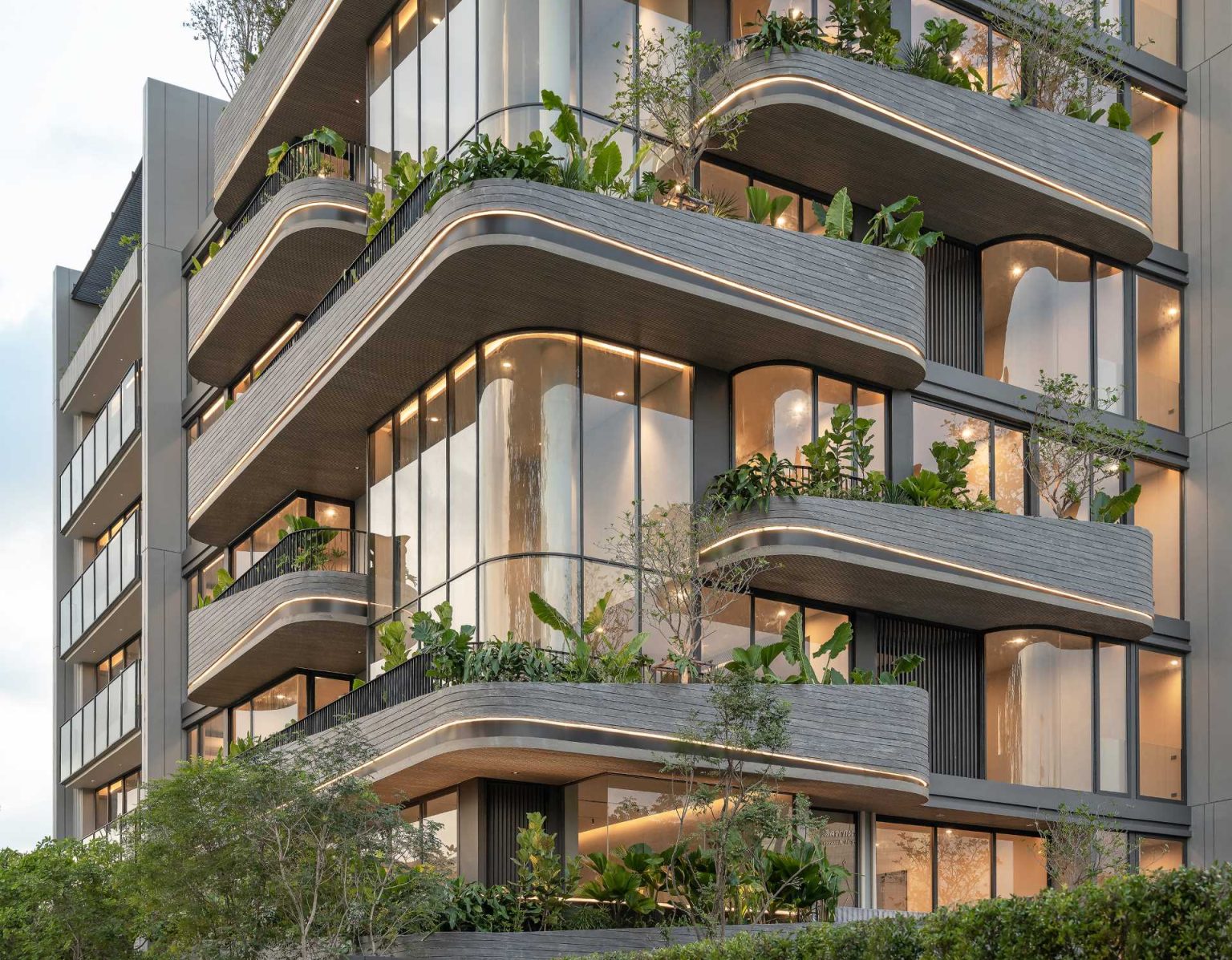 Lighting Is Used To Highlight The Rounded Balconies Of This Building