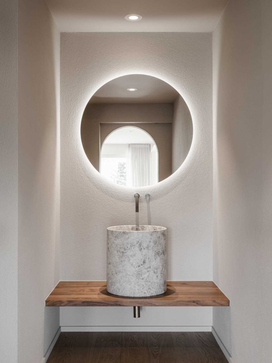 A Round Fireplace Is A Unique Feature In The Living Room Of This ...