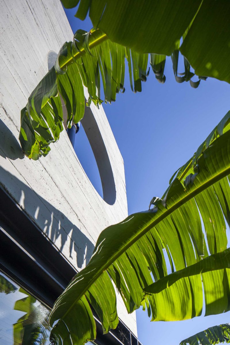 A Round Window Is Nestled Into A Stone Wall On The Front Of This Home