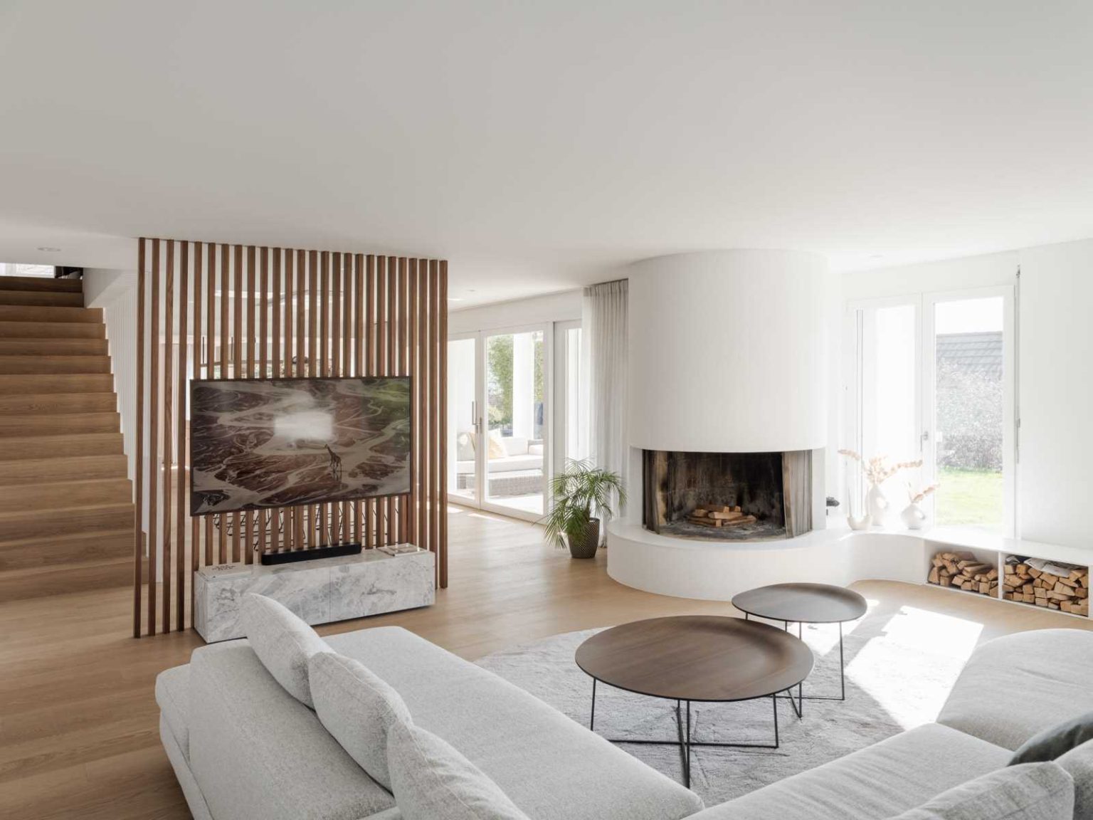 A Round Fireplace Is A Unique Feature In The Living Room Of This ...